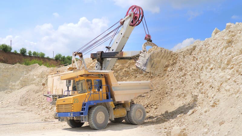An Excavator in Action on a Construction Site. an Excavator and a Truck ...