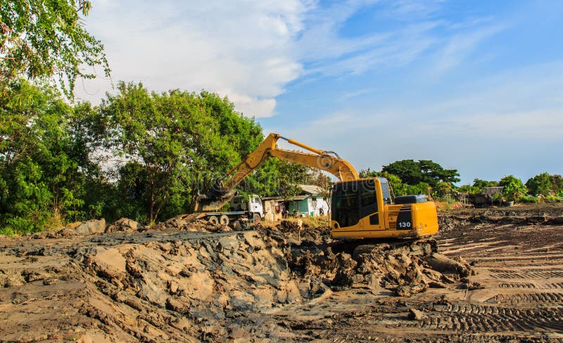 Excavator in action stock image. Image of road, building - 68473255