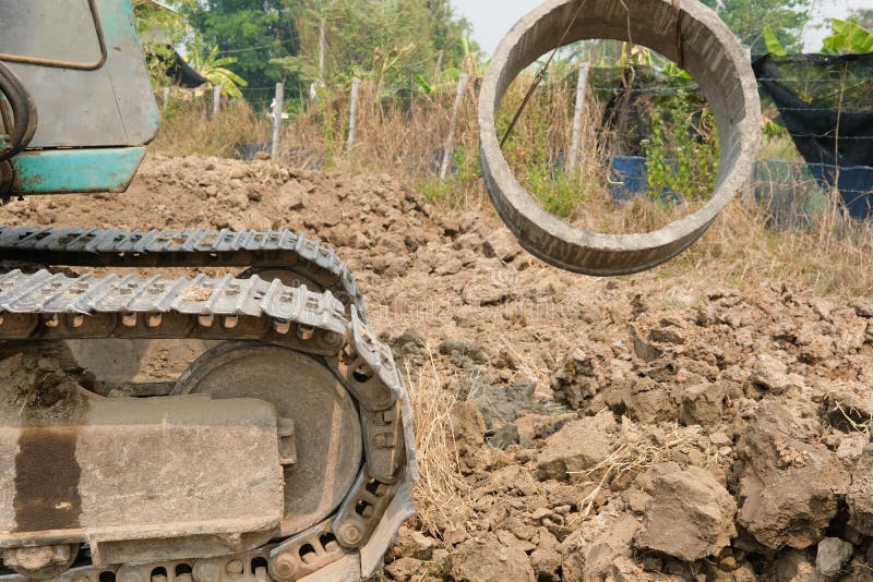 Excavator Backhoe Raising Pipe at Construction Site Stock Photo - Image ...