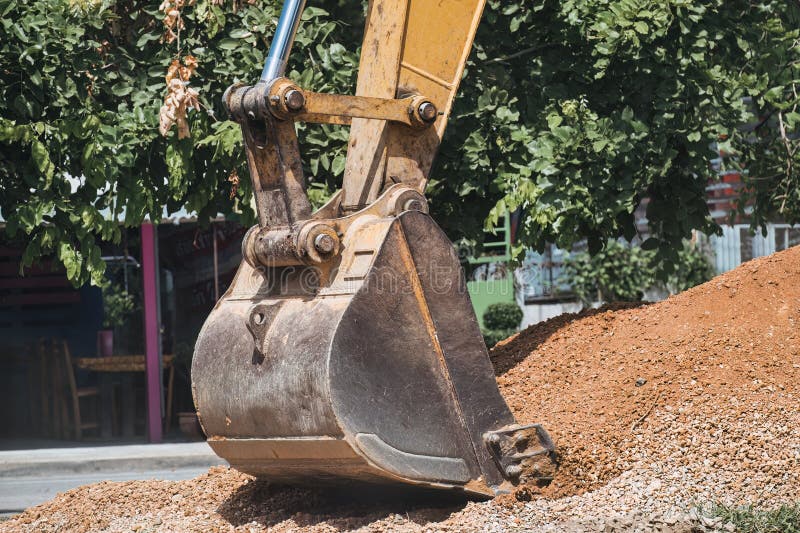 Excavator Digging Soil and Stone on Construction Site Stock Photo ...