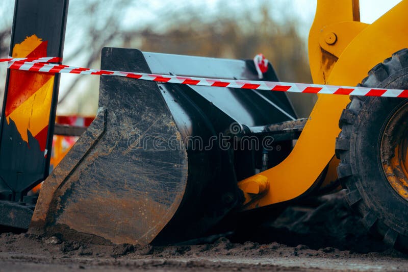 Excavator Behind a Warning Tape on a Construction Site Stock Image ...