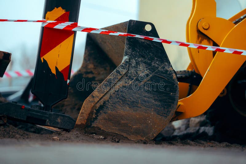Excavator Behind a Warning Tape on a Construction Site Stock Image ...