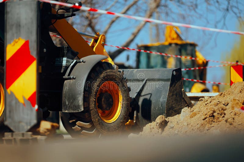 Excavator Behind a Warning Tape on a Construction Site Stock Image ...