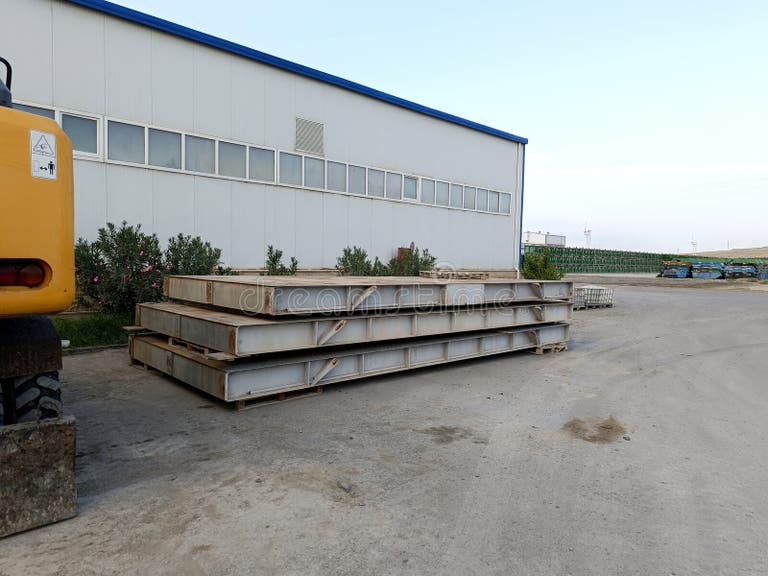 An Excavator on a Break Near a Warehouse, Next To a Container Stock ...