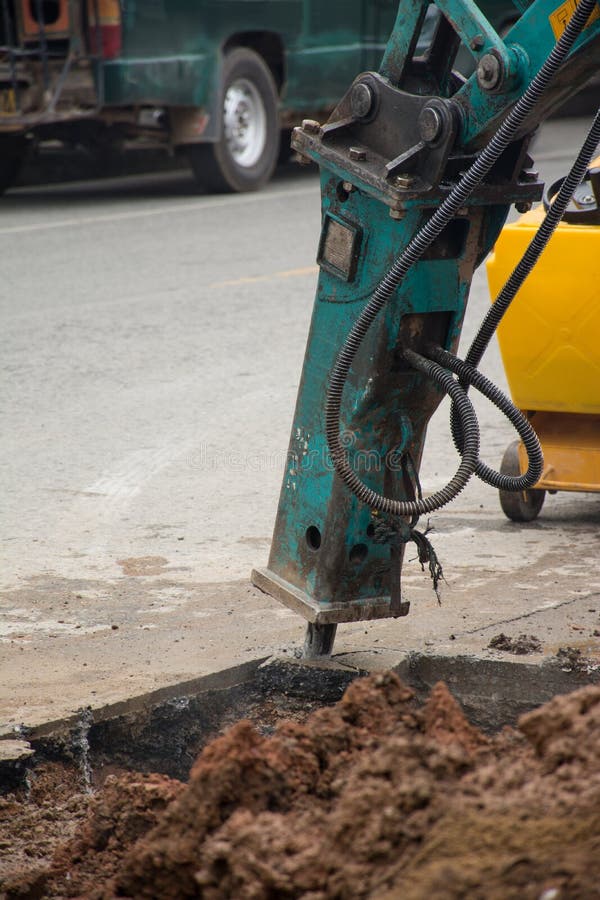 Excavator Breaking and Drilling the Concrete Road . Stock Image - Image ...