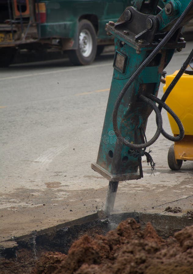 Excavator Breaking and Drilling the Concrete Road . Stock Image - Image ...