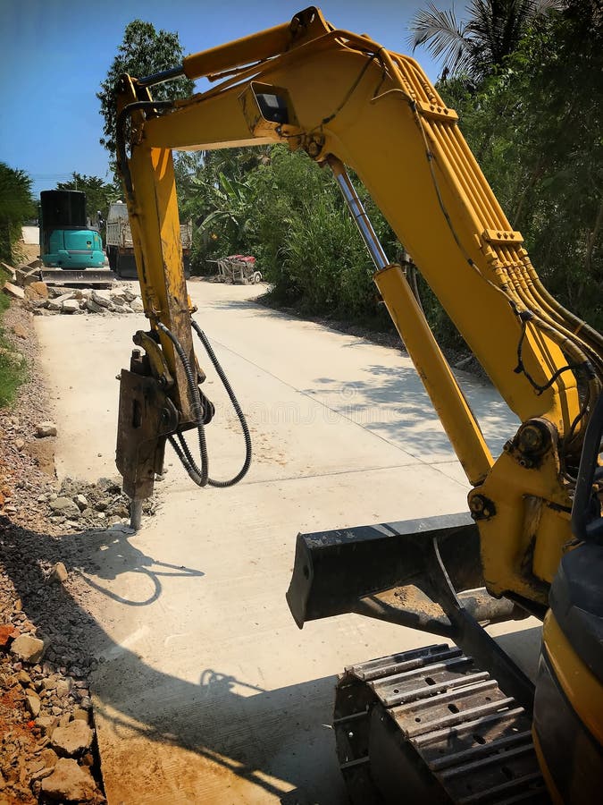 Excavator Breaking and Drilling the Concrete Road for Repairing Stock ...