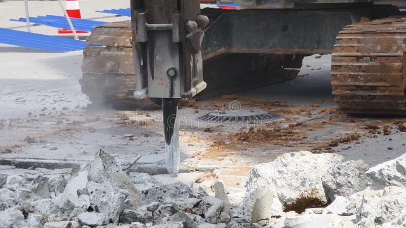 An Excavator Breaks Down a Layer of Concrete Pavement before ...