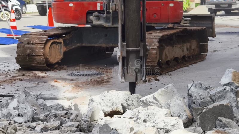 An Excavator Breaks Down a Layer of Concrete Pavement before ...