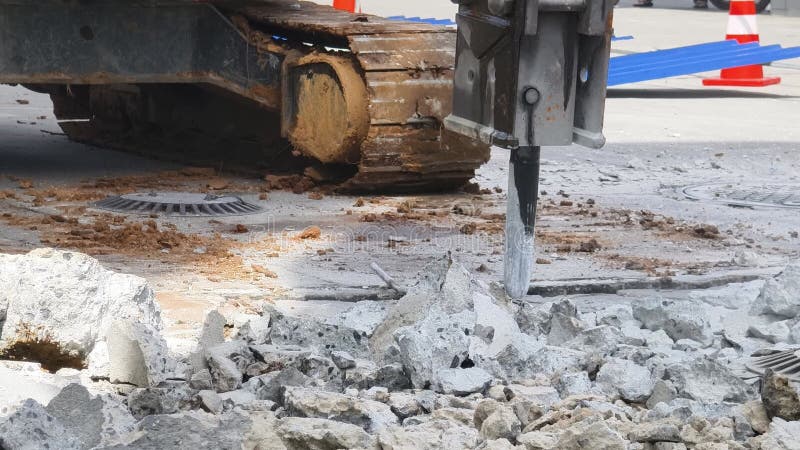 An Excavator Breaks Down a Layer of Concrete Pavement before ...