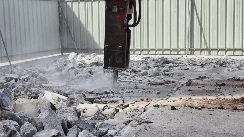 An Excavator Breaks Down a Layer of Concrete Pavement before ...