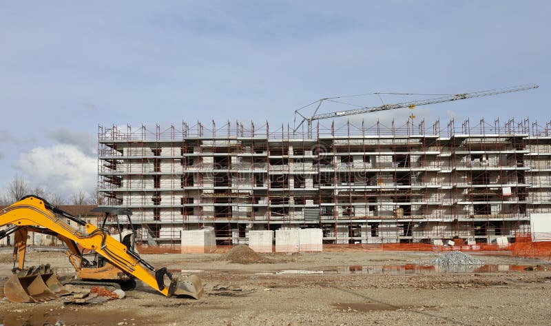 Excavator Bucket and Boom in Front of a Large Residential Building ...