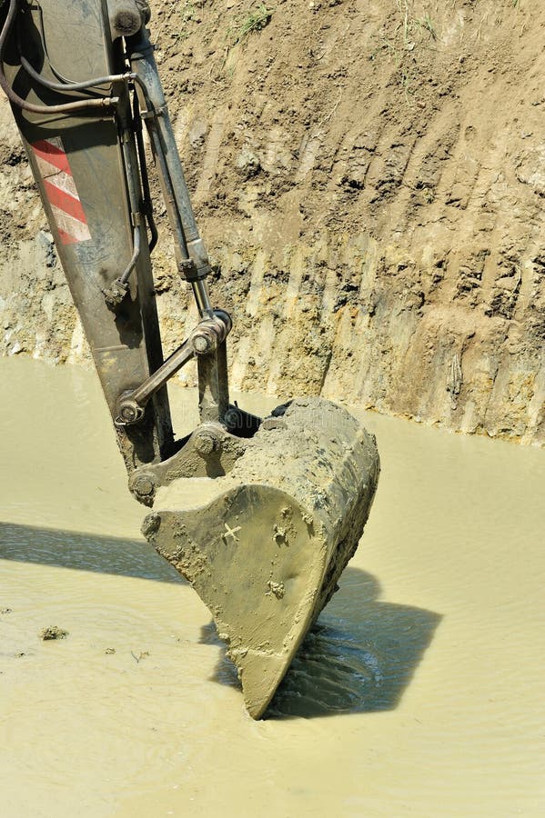 Excavator Bucket Collecting Water Stock Image - Image of steam ...