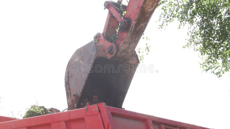The Excavator Bucket Digs a Pit in the Ground for Laying Heating Pipes ...