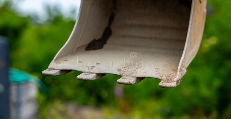 Excavator Bucket with Four Teeth and Dirt in Outdoor Setting.. Stock ...