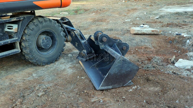 An Excavator Bucket is Positioned on the Ground, Ready for Digging Work ...