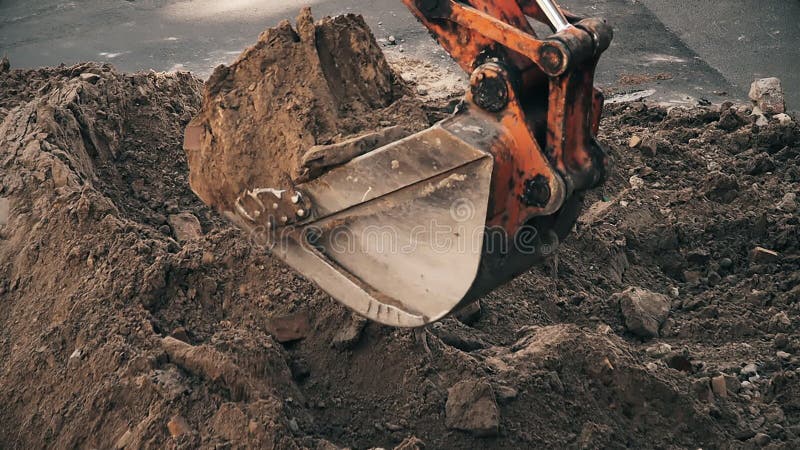 Excavator Bucket Scoop Removes the Top Layer of Soil and Levels it ...