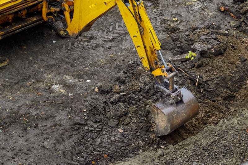 Excavator Bucket Starts To Dig the Ground. Stock Image - Image of ...