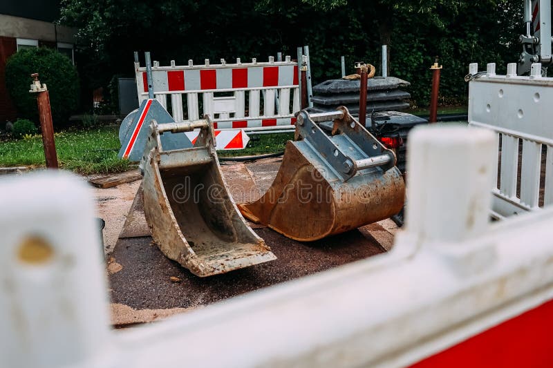 Excavator Buckets Placed on Pavement Area. Stock Photo - Image of ...