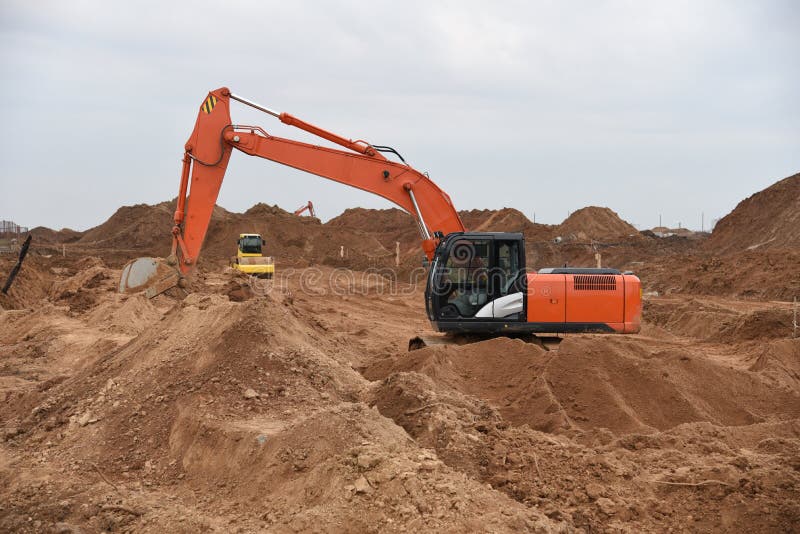 Excavator at Building Under Construction. Backhoe Digs the Ground for ...