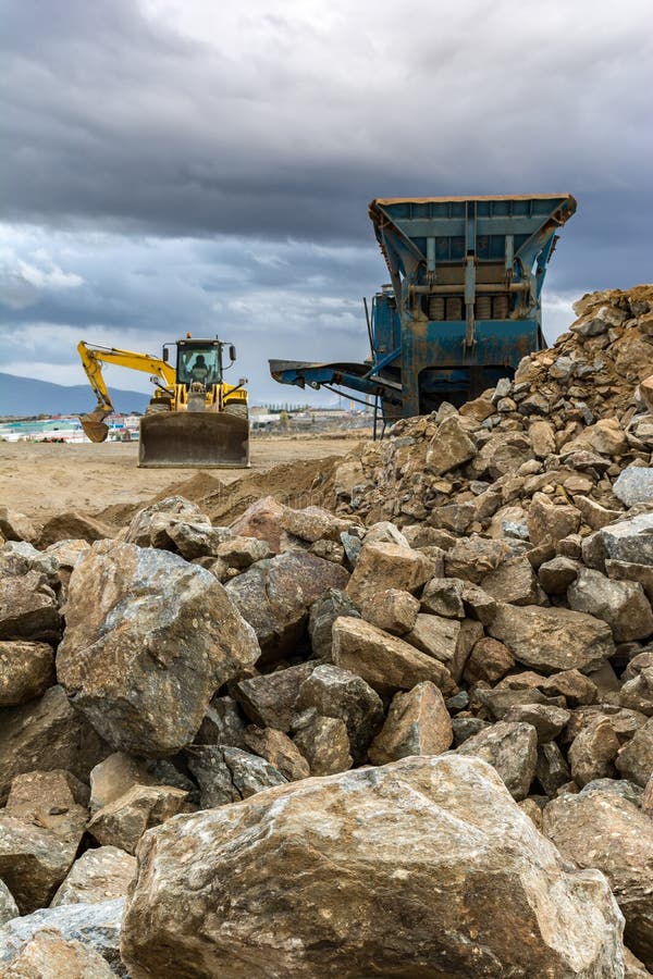 Excavator Collecting Stone in an Open-cast Mine Stock Photo - Image of ...