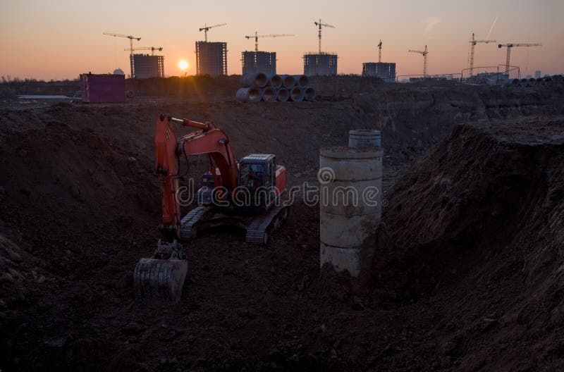 Excavator at a Construction Site on a Background of a Construction ...