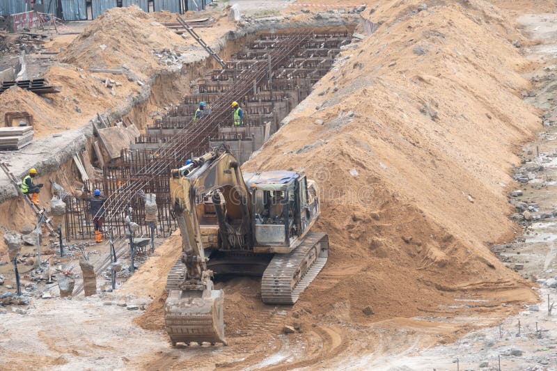 Excavator at a Construction Site with Construction Meterial in a Sandy ...