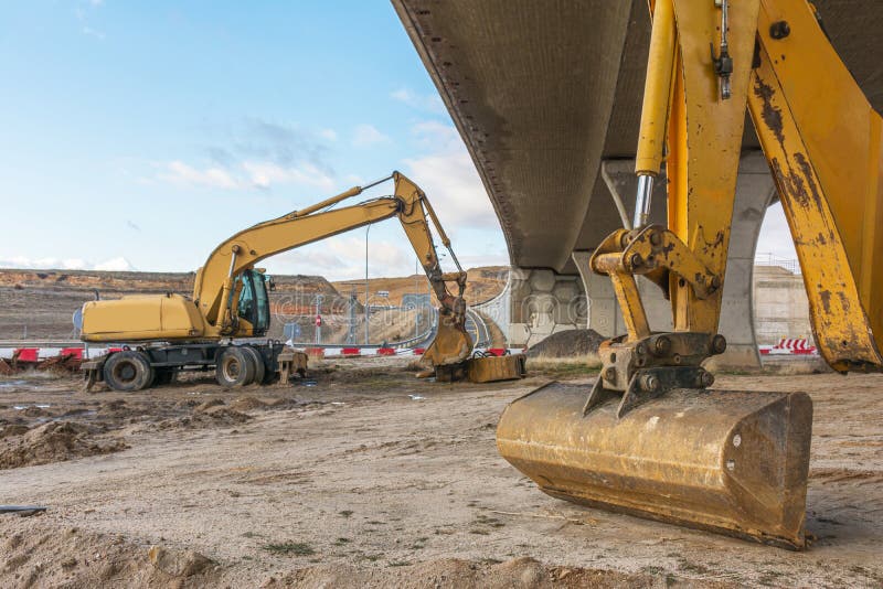 Excavator at the Construction Works of a Bridge in the Extension of a ...
