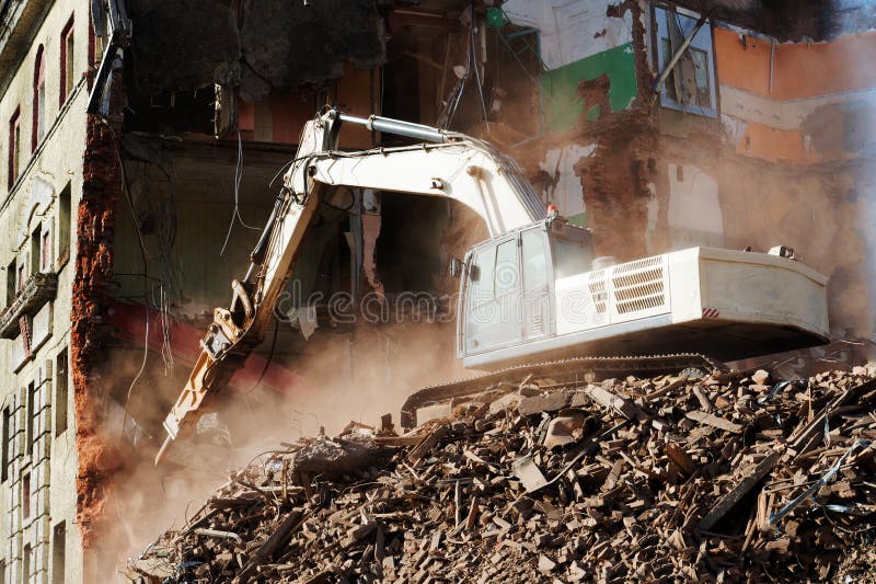 Excavator Demolishing a Brick Building. Machinery Demolishing Building ...