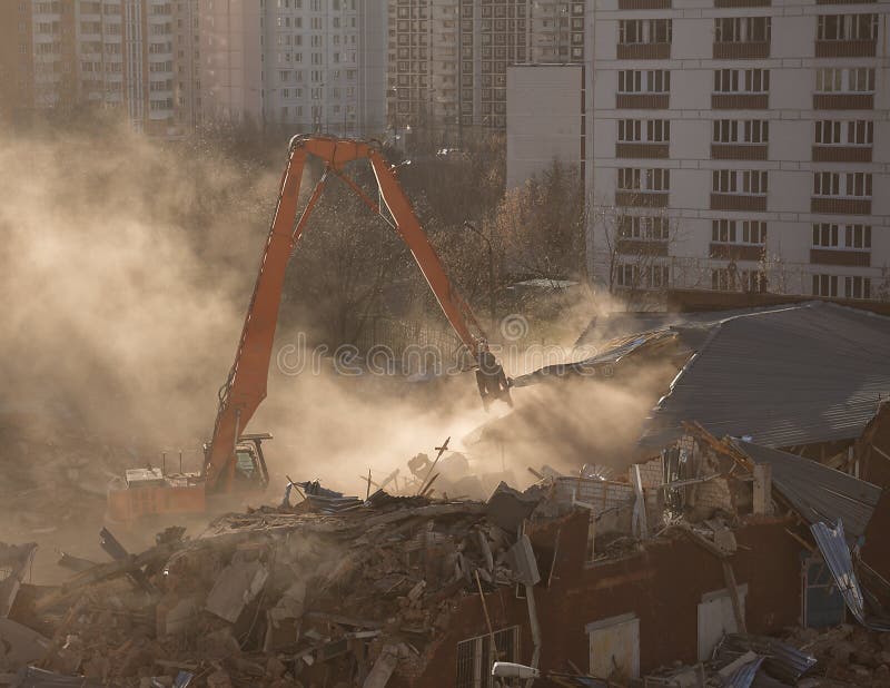 Excavator Demolition in Sunlit Dust Cloud Dismantles the Building in ...