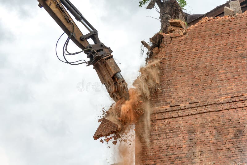 Excavator Destroyer Breaks a Brick Wall. Stock Photo - Image of ...