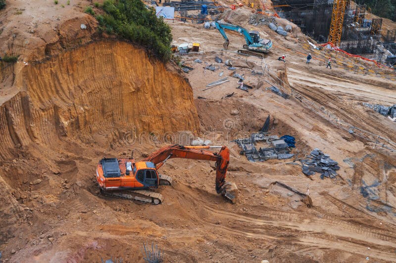 Excavator Dig Ground in the Foundation Pit of Building on a ...