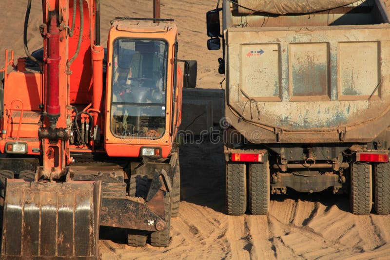 Excavator Digger and Dump Truck at a Construction Site Stock Image ...
