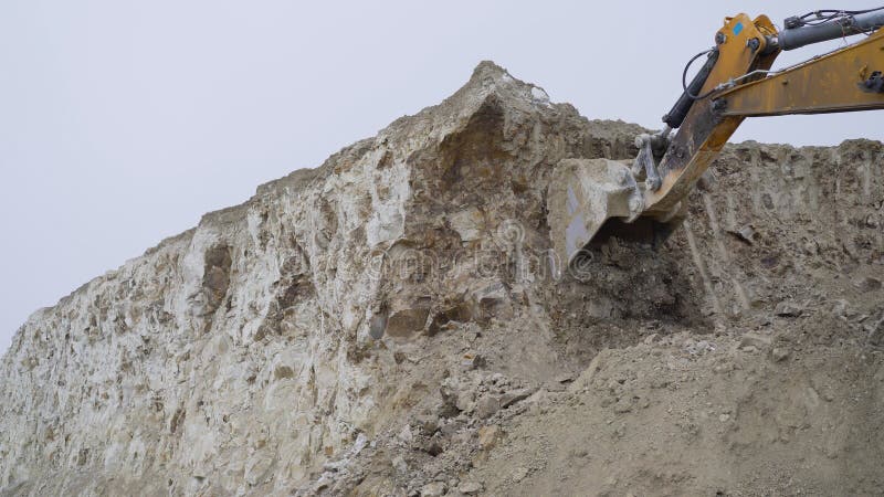 Excavator Digging on a Chalk Cliff during Mining Operations Stock Image ...