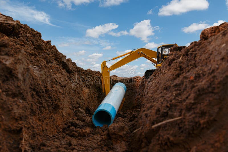 Excavator is Digging in the Construction Site Pipeline. Stock Photo ...