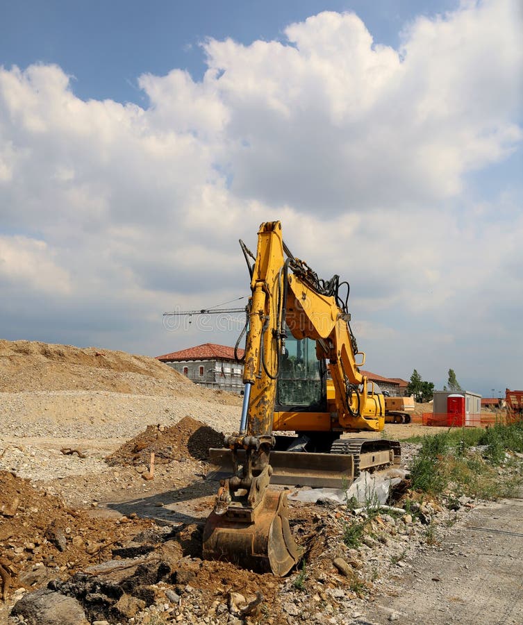 Excavator Digging the Dirt Area at the Edge of the Construction Site ...