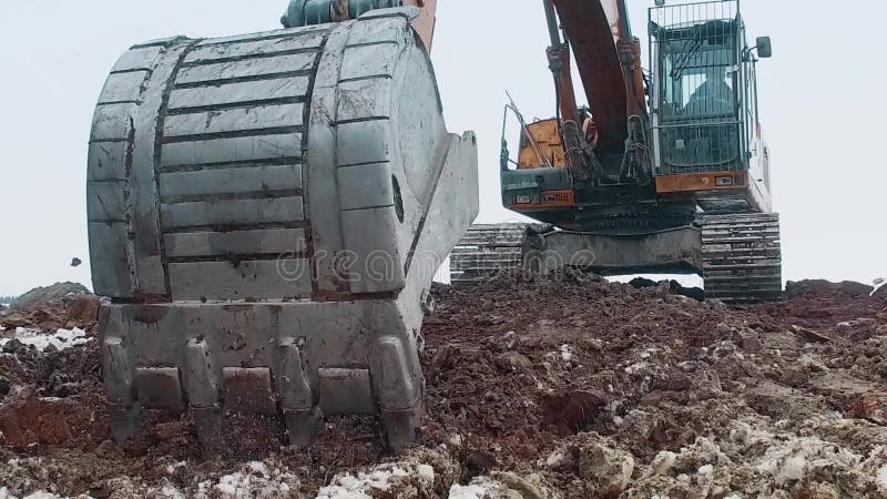 Excavator is Digging the Frozen Ground in Winter Day Stock Footage ...