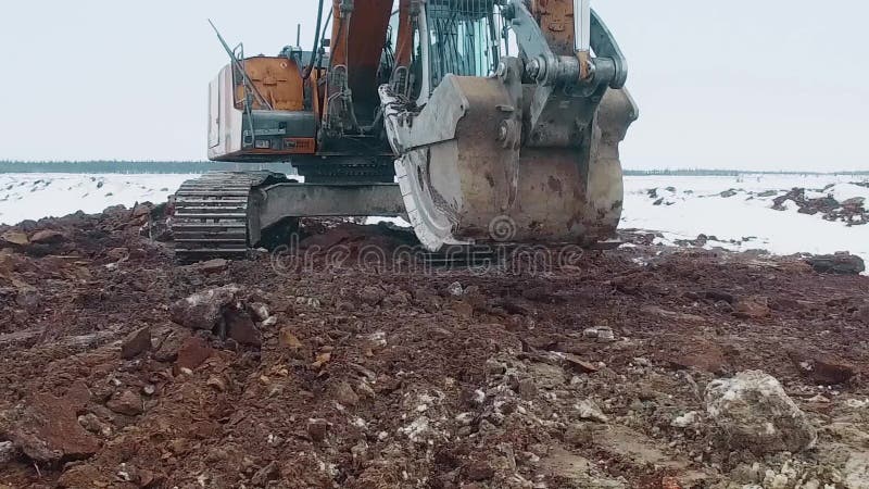 Excavator is Digging the Frozen Ground in Winter Day Stock Footage ...