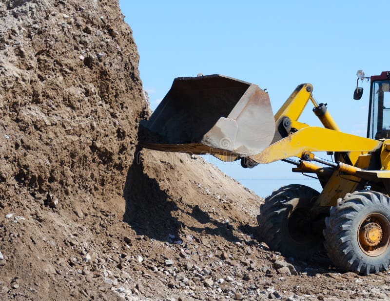 Excavator Digging Gravel Pile for Loading in the Truck Stock Image ...