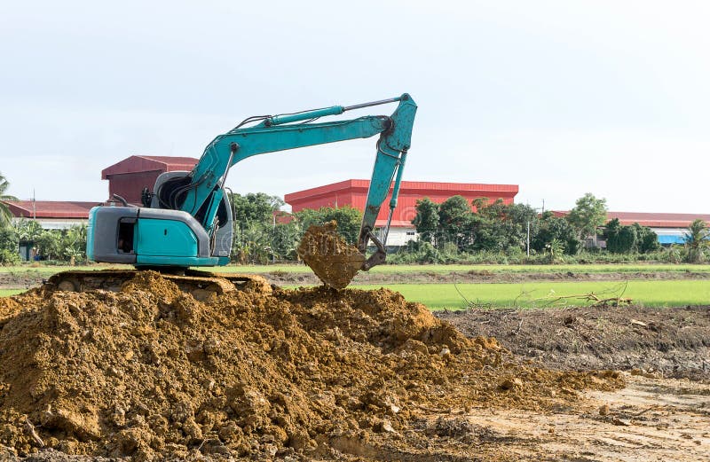 Excavator Digging the Ground in the Rural. Construction Site in ...