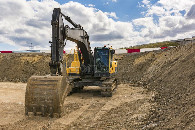 Excavator Digging a Hole on a Road Construction Site Editorial Stock ...