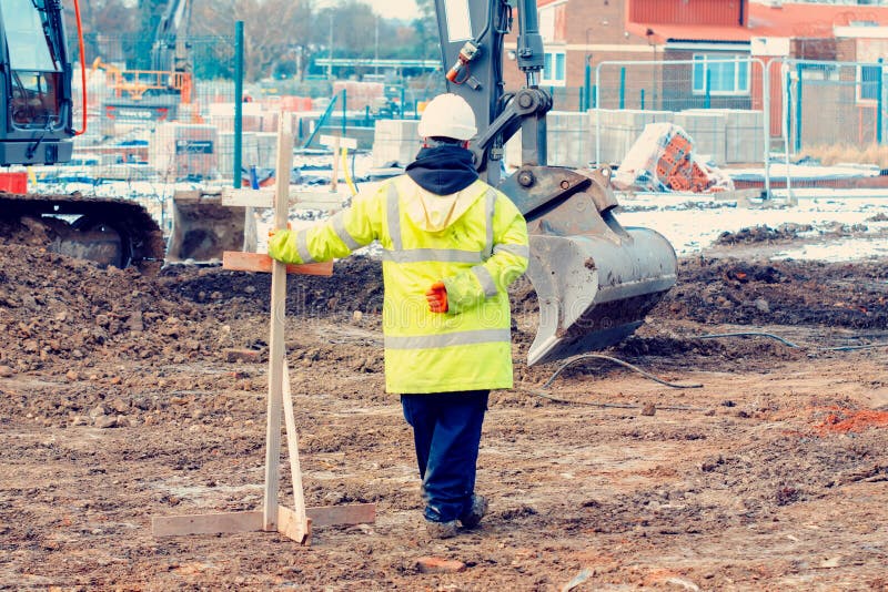 Excavator Digging and Levelling Ground on Construction Site. Digging To ...