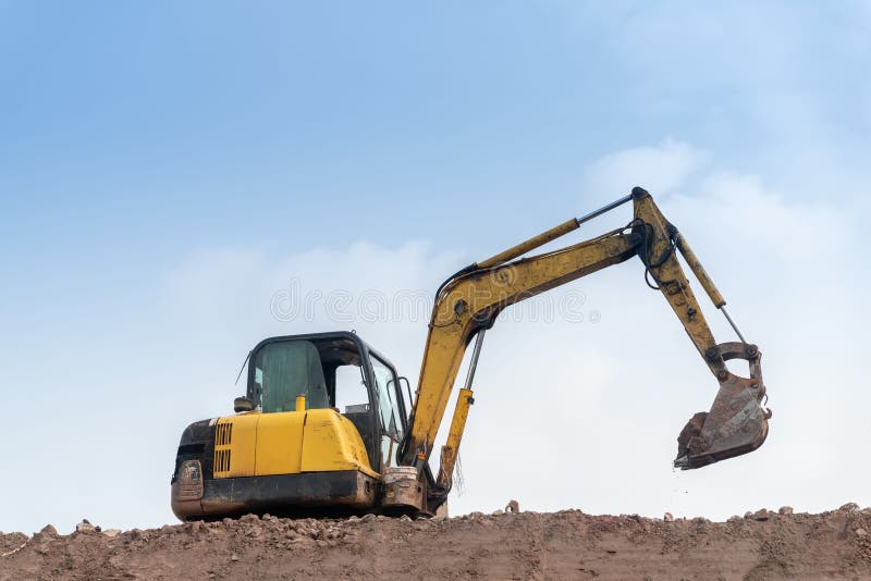 Excavator Digging and Loading Dirt at the Construction Site with Clear ...