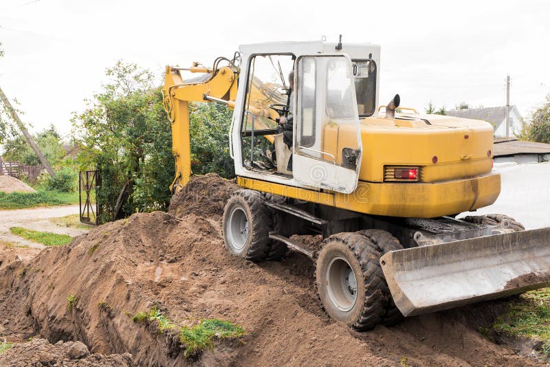 A Excavator is Digging on Outdoors in an Industrial Site. Excavation ...