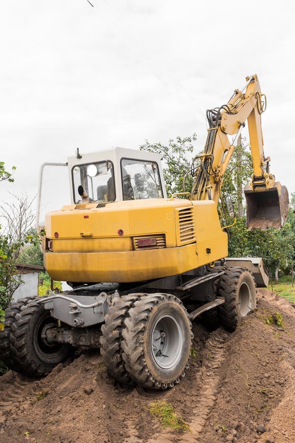 A Excavator is Digging on Outdoors in an Industrial Site. Excavation ...