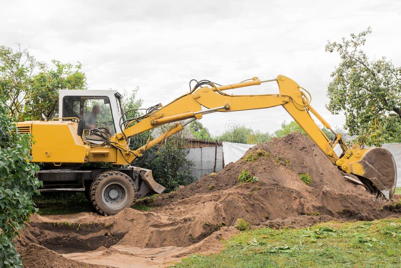 A Excavator is Digging on Outdoors in an Industrial Site. Excavation ...