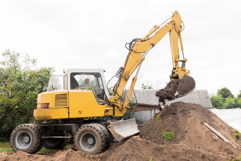 A Excavator is Digging on Outdoors in an Industrial Site. Excavation ...