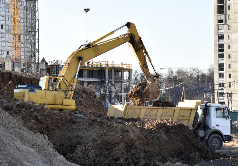 Excavator Digging Sand and Loading into Dump Truck on Construction Site ...