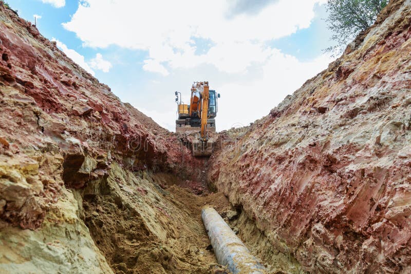 Excavator Digging a Trench for the Pipeline Stock Photo - Image of ...