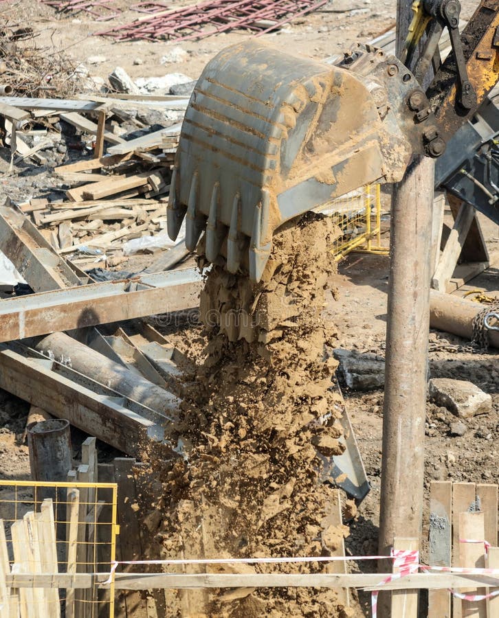 Excavator Digs the Ground at a Construction Site. Stock Image - Image ...